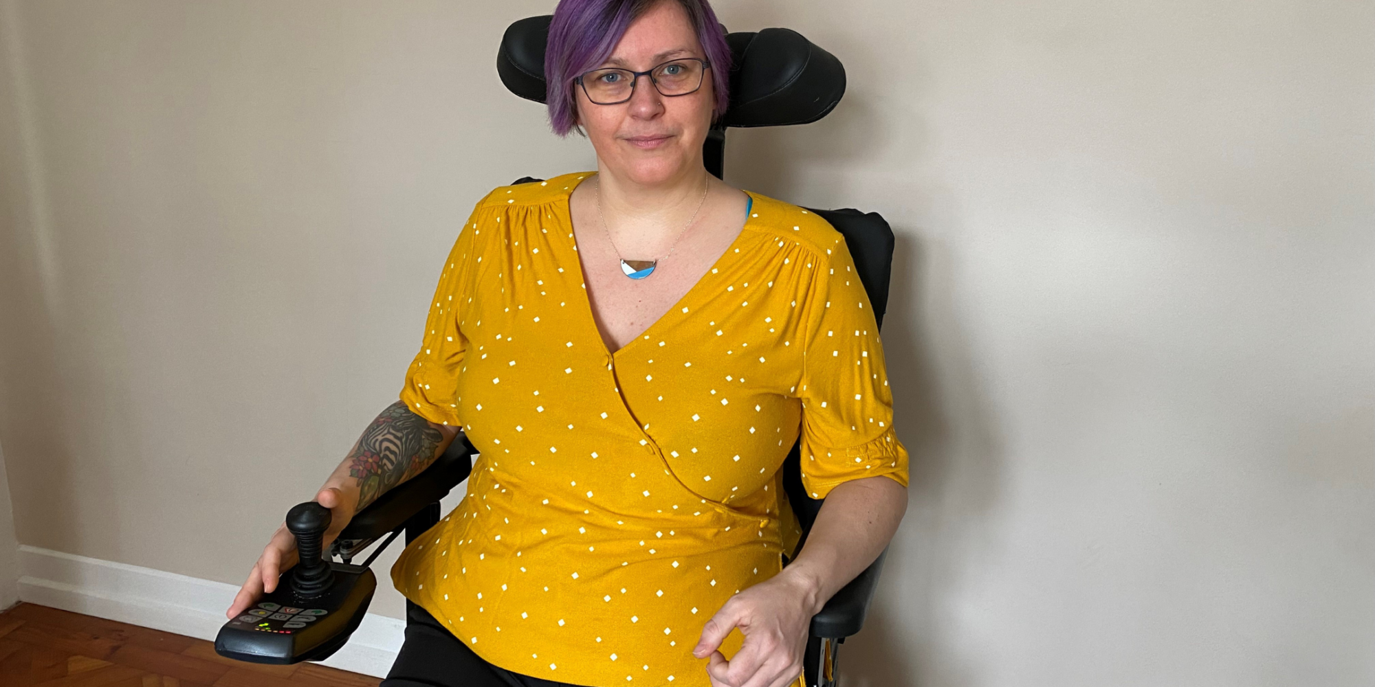 Aimee wheelchair picture purple hair yellow top 1 19.10.22 - Baby Friendly Initiative